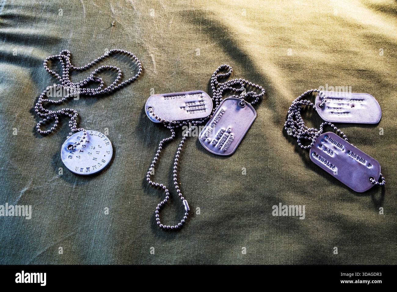 Still life of three generations of military ID tags from the same ...