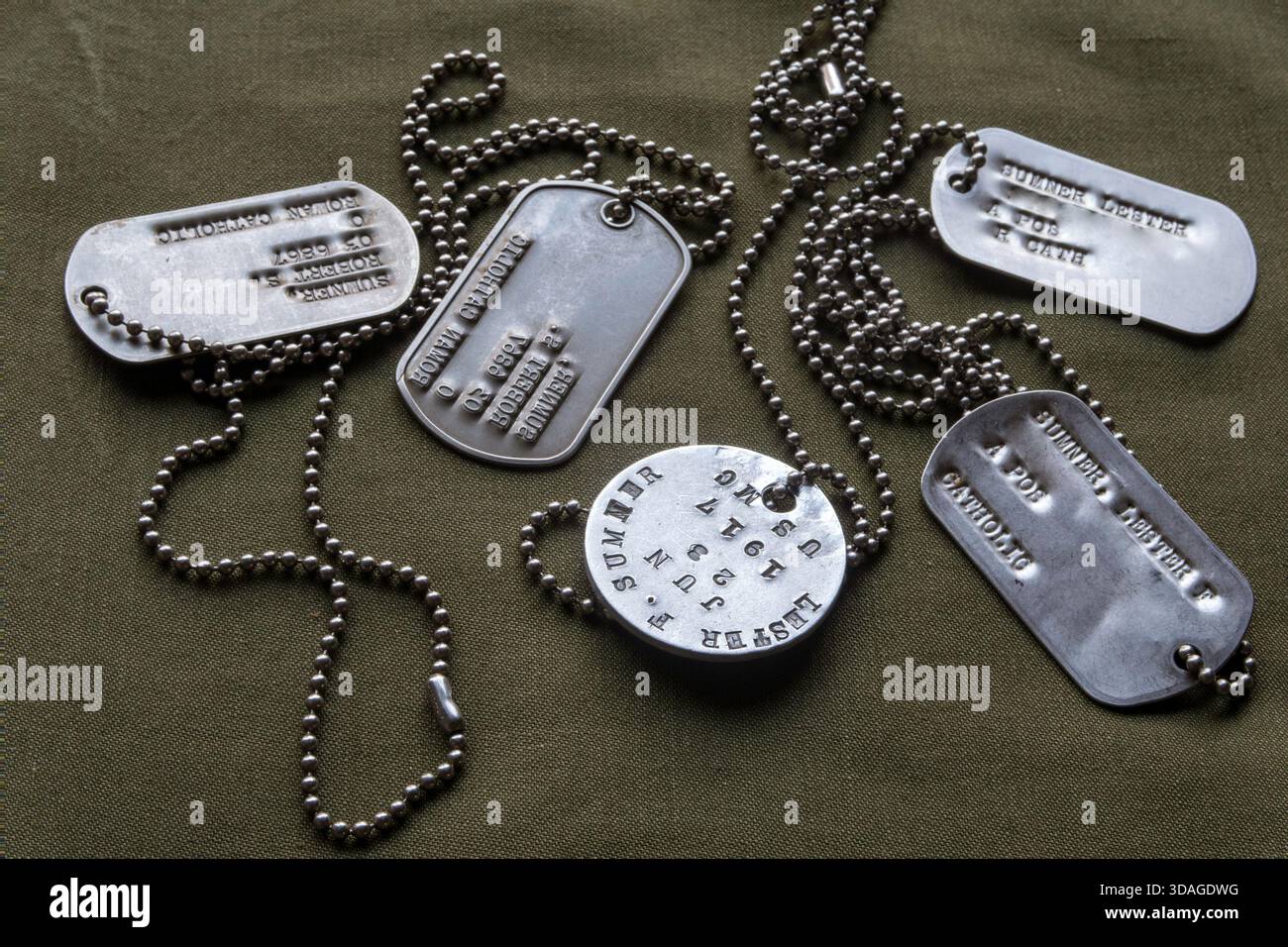 Still life of three generations of military ID tags from the same ...