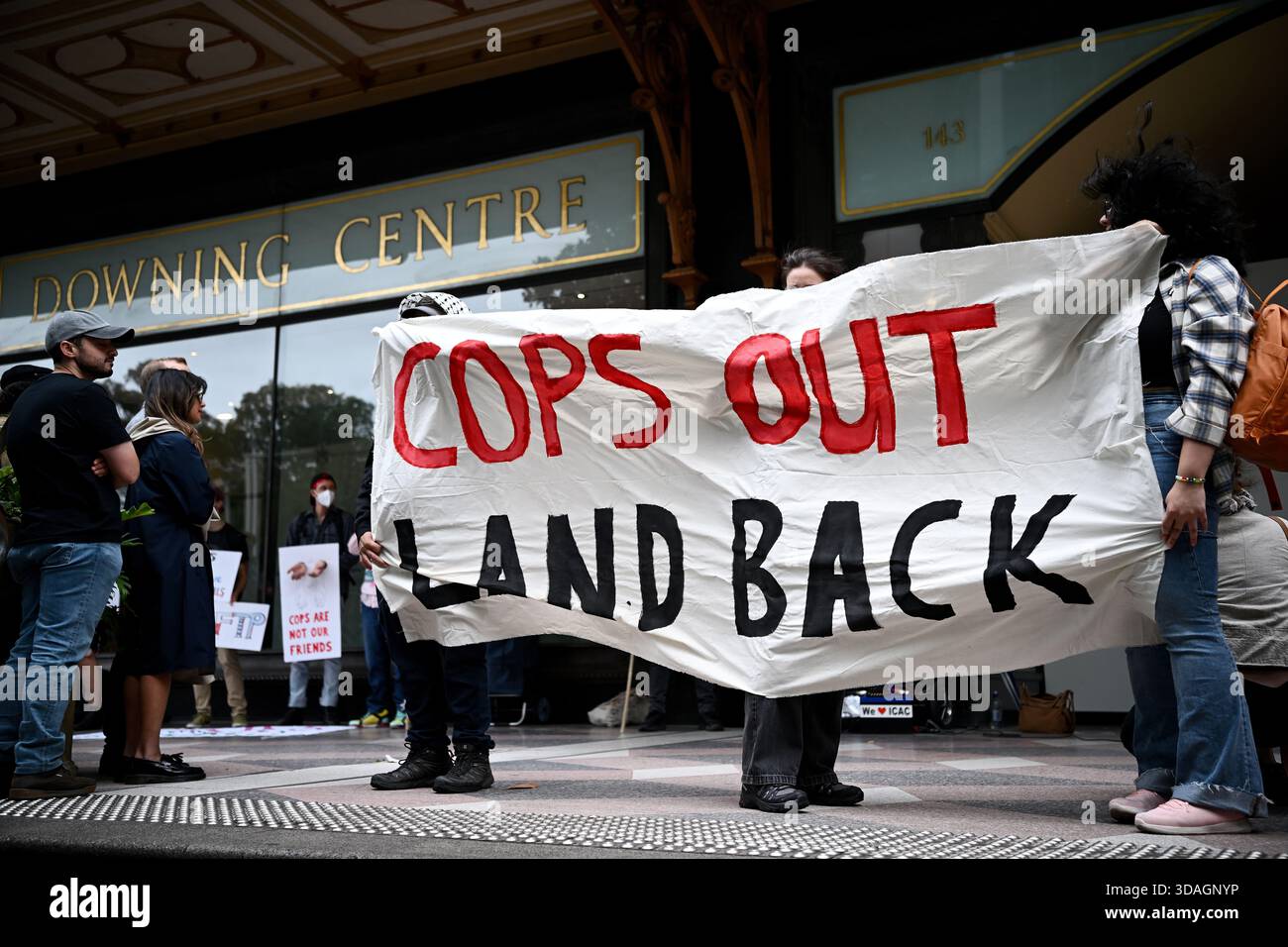 Protesters hold placards during a Watch The Cops rally against police ...