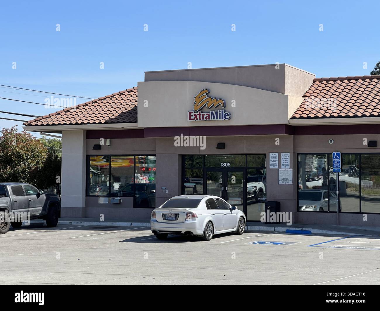 Exterior of a Chevron ExtraMile convenience store with tiled roof and ...