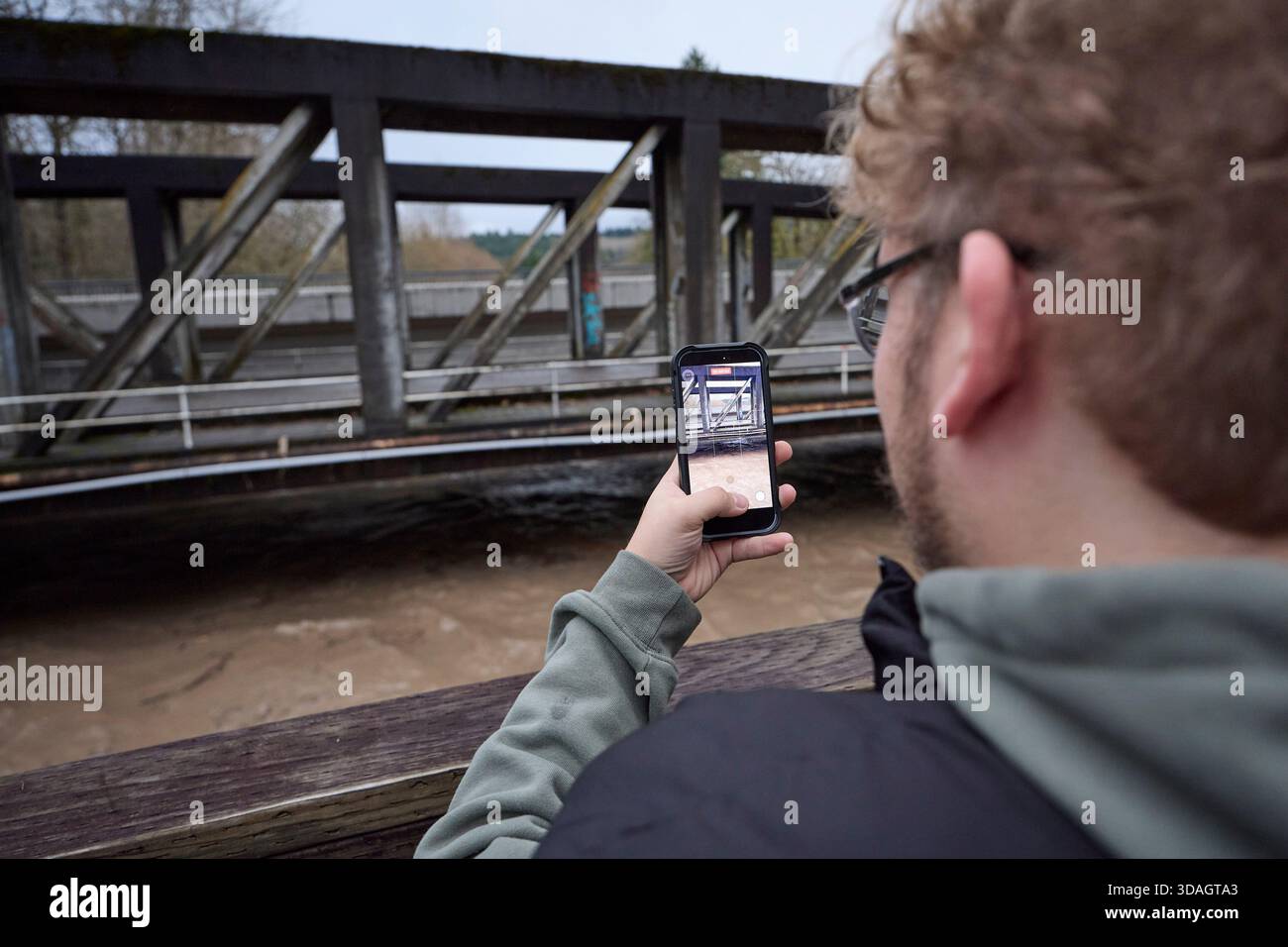 Kaden Nelson takes video of the Puyallup River during flooding from a ...
