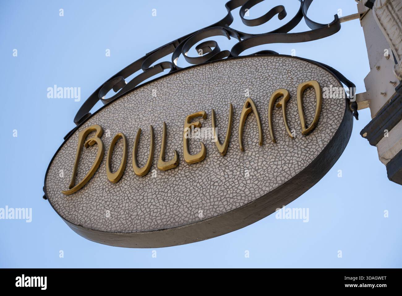 Oval hanging sign with gold Boulevard lettering and wrought iron ...