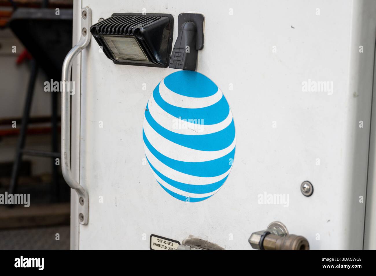 AT&T logo sticker on white utility vehicle with work light and metal ...