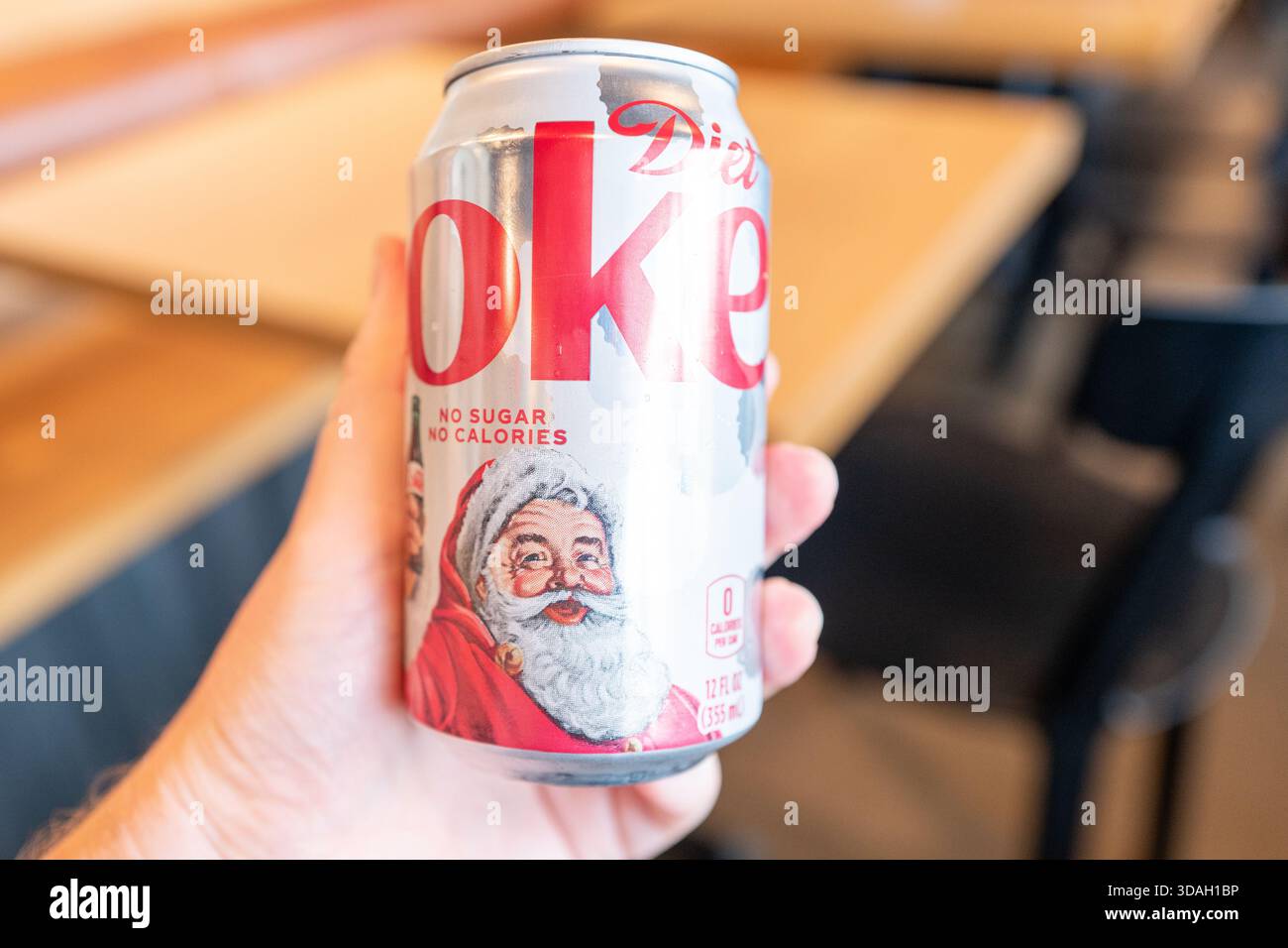 Person's hand holding a Coca Cola Diet Coke can with a stylized image ...