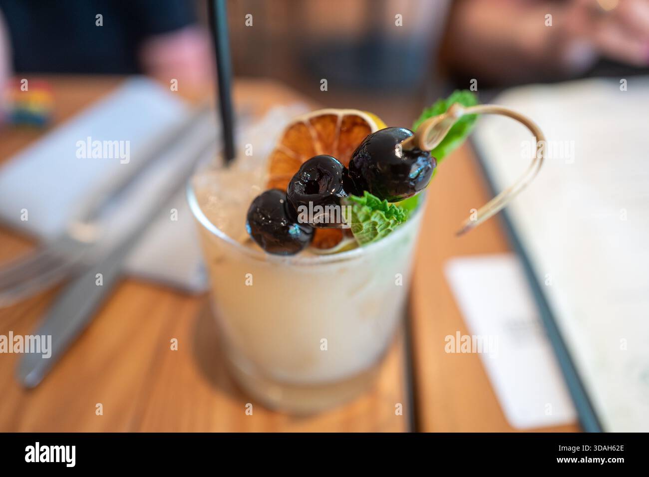 Close-up of a Mai Tai cocktail with maraschino cherries in a restaurant ...
