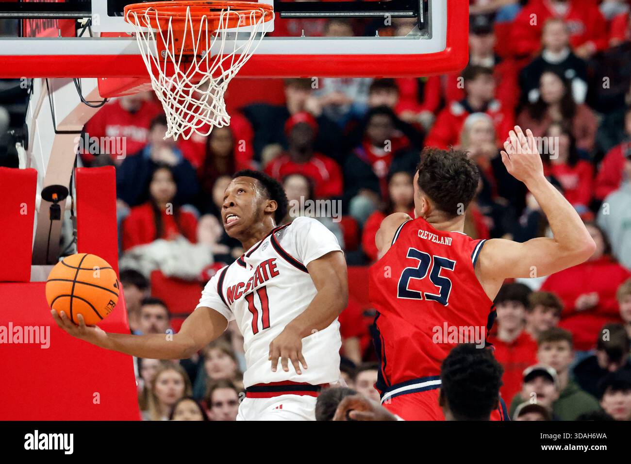NC State's Quadir Copeland (11) drives the ball past Liberty's Zach ...