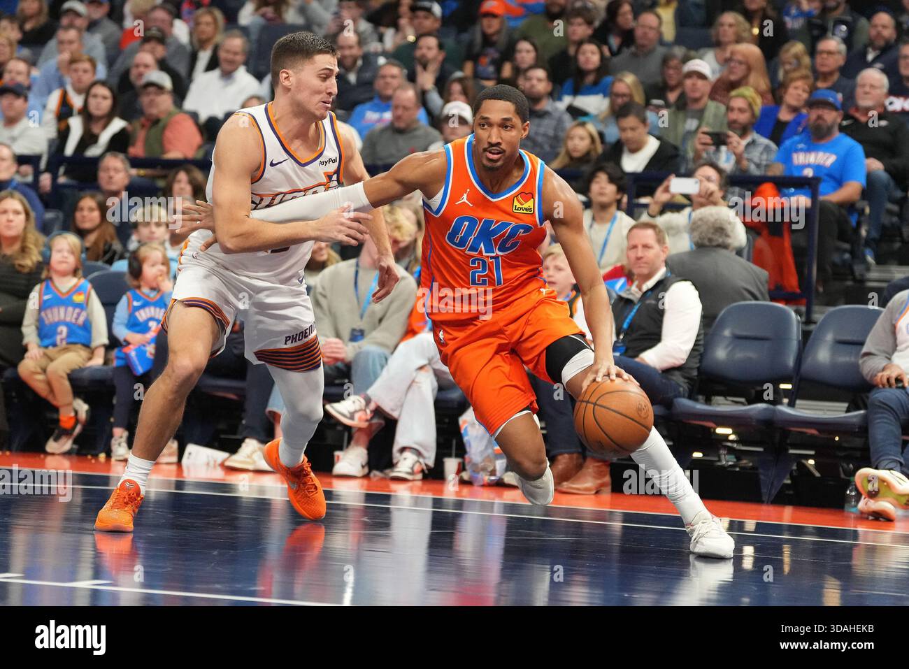 Oklahoma City Thunder guard Aaron Wiggins, right, drives past Phoenix ...