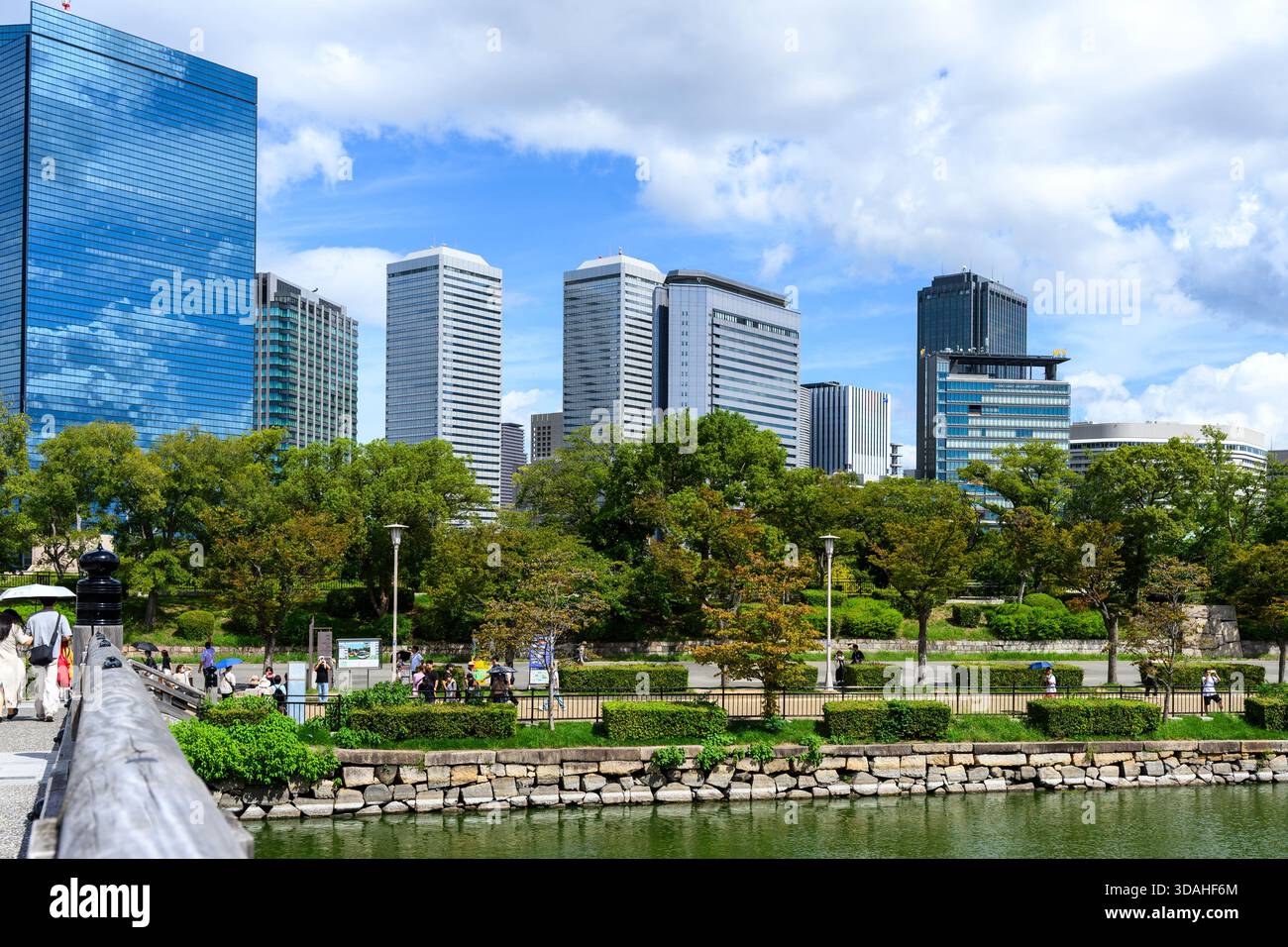 Modern skyscrapers of the Osaka Business Park rise behind the lush ...