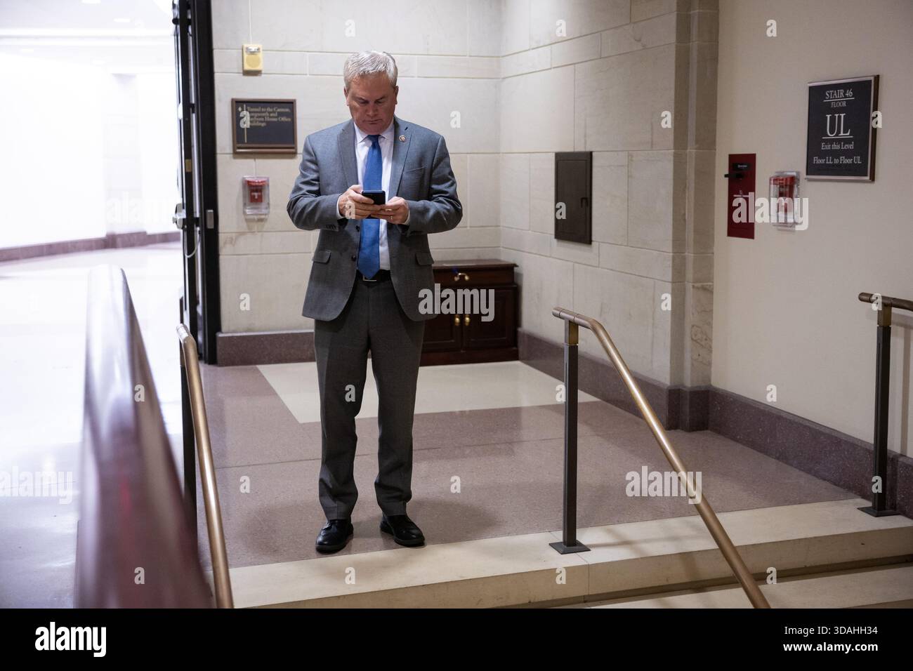 Rep. James Comer (R-Ky.) uses his phone on Capitol Hill Dec. 10, 2025 ...