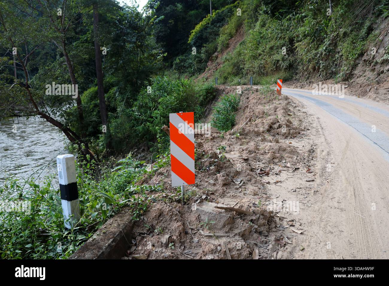 Dangerous landslide collapses on rural mountain road, with soil and ...