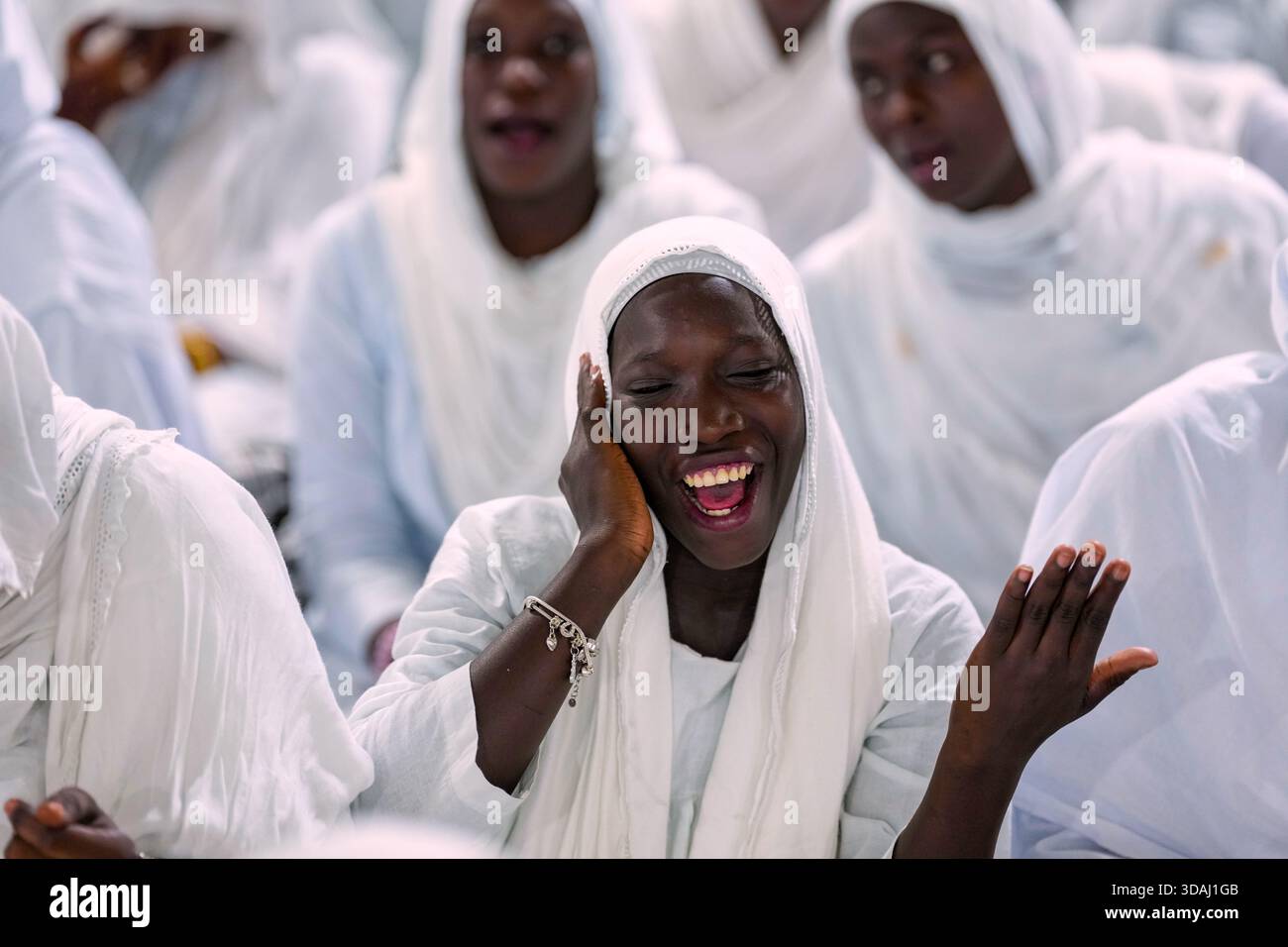 A woman recites prayers as people mark Prophet Muhammad's birthday ...