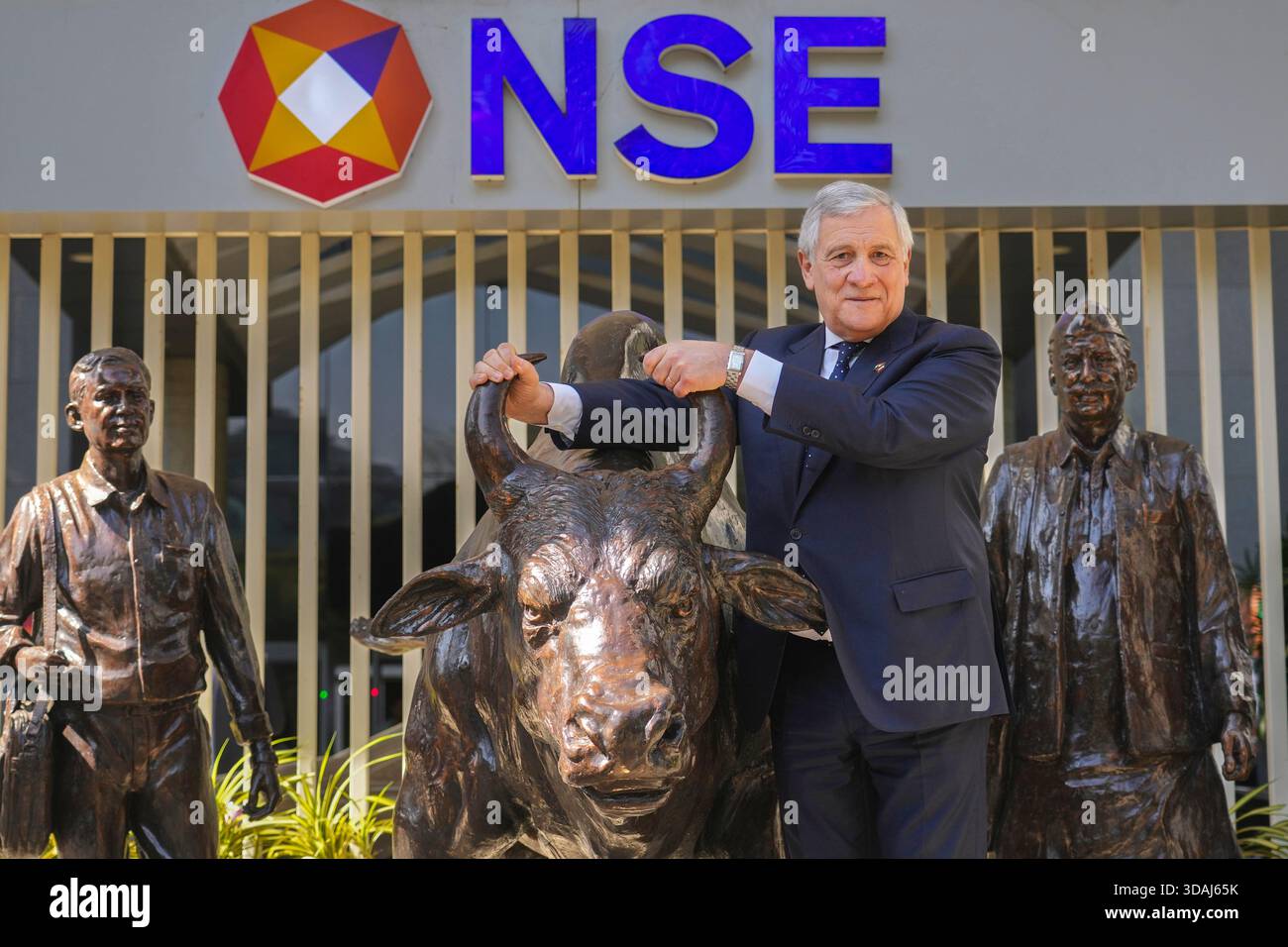 Italian Foreign Minister Antonio Tajani poses with the statue of the ...