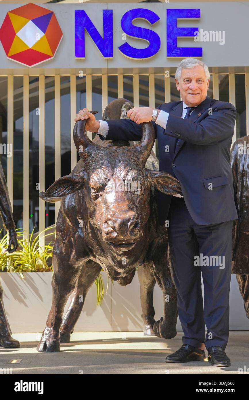 Italian Foreign Minister Antonio Tajani poses with the statue of the ...