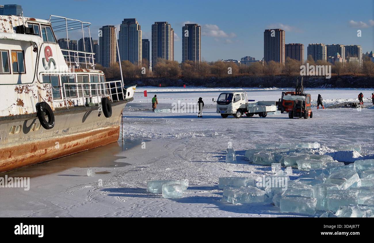 Workers collect ice from the Songhua river in Harbin City, northeast ...