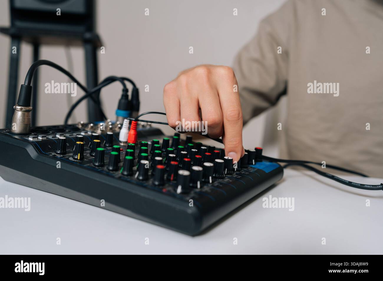 Close-up hands of sound engineer adjusting audio mixing console, tuning ...