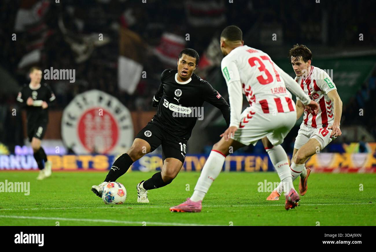 from left Joel Chima Fujita (St. Pauli), Linton Maina, Jakub Kaminski Cologne, December 6, 2025 ...