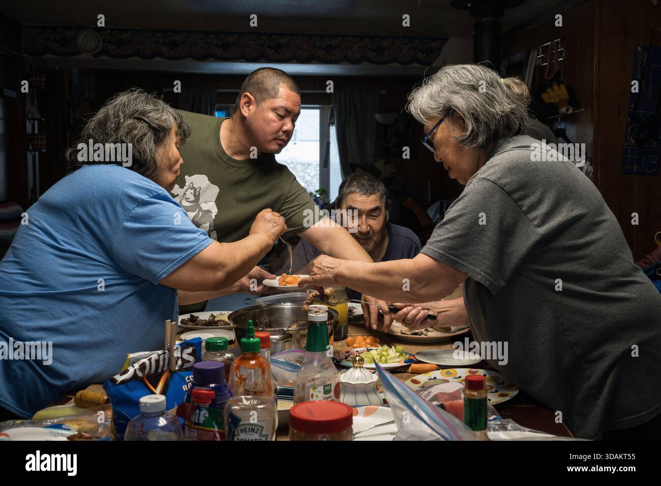Tristen Pattee and his family eat a meal of beluga whale, bowhead whale ...