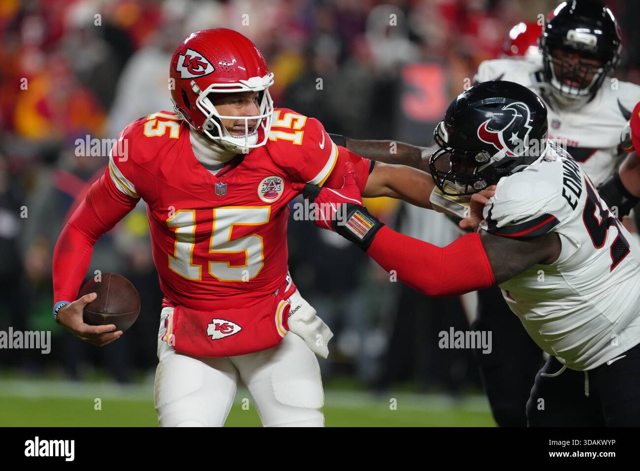 Kansas City Chiefs quarterback Patrick Mahomes (15) tries to avoid a ...