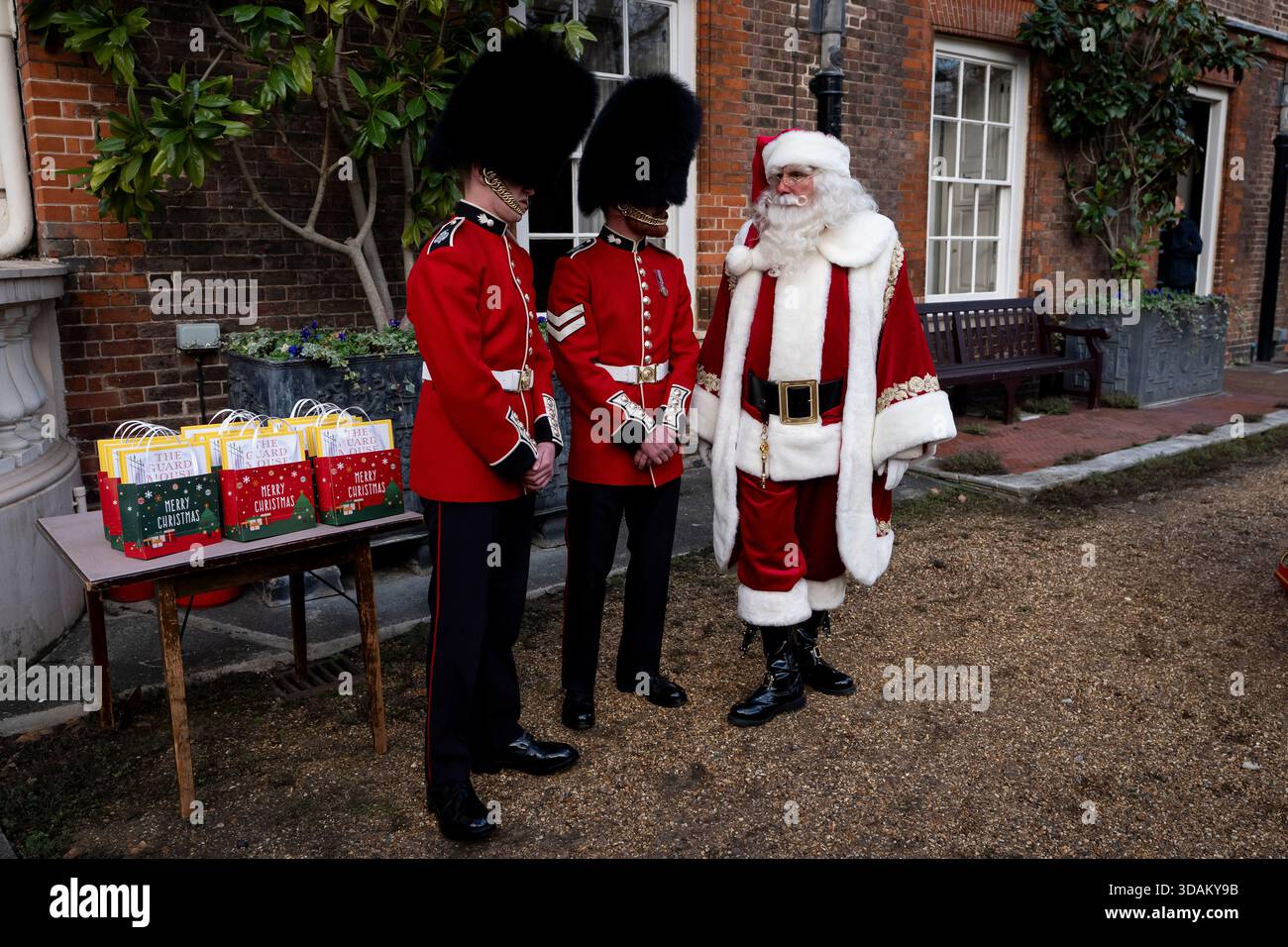 A person dressed as Father Christmas meets members of the Coldstream ...