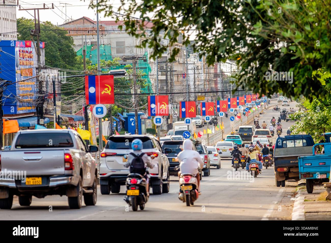 Lao and communist flags flying in the main street of Pakse, Laos Stock ...