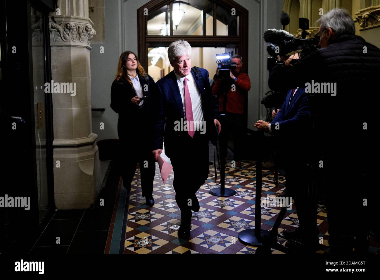 Minister of Energy and Natural Resources Tim Hodgson walks past ...