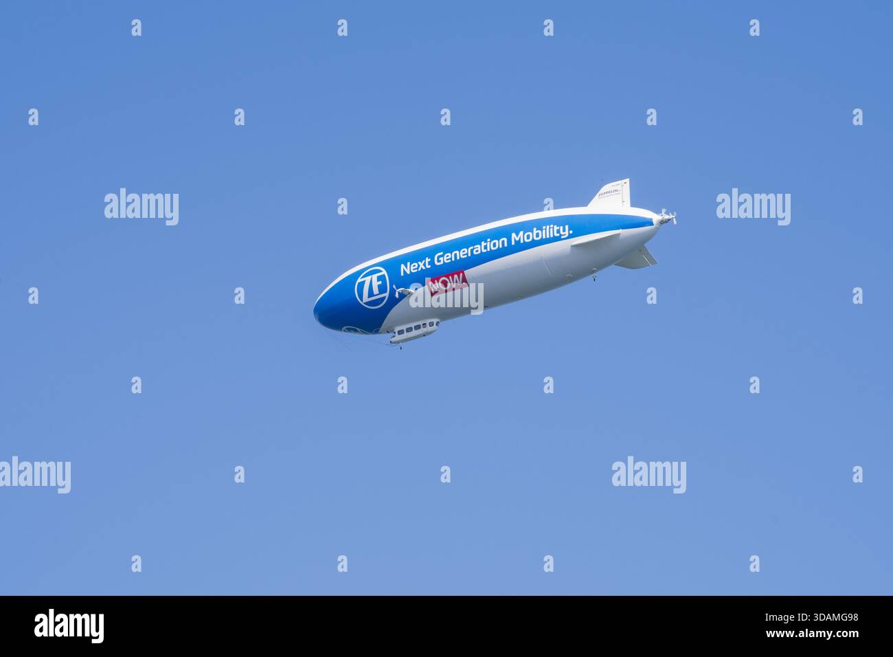 Modern ZF Zeppelin flying in clear blue sky, showing sleek shape and ...
