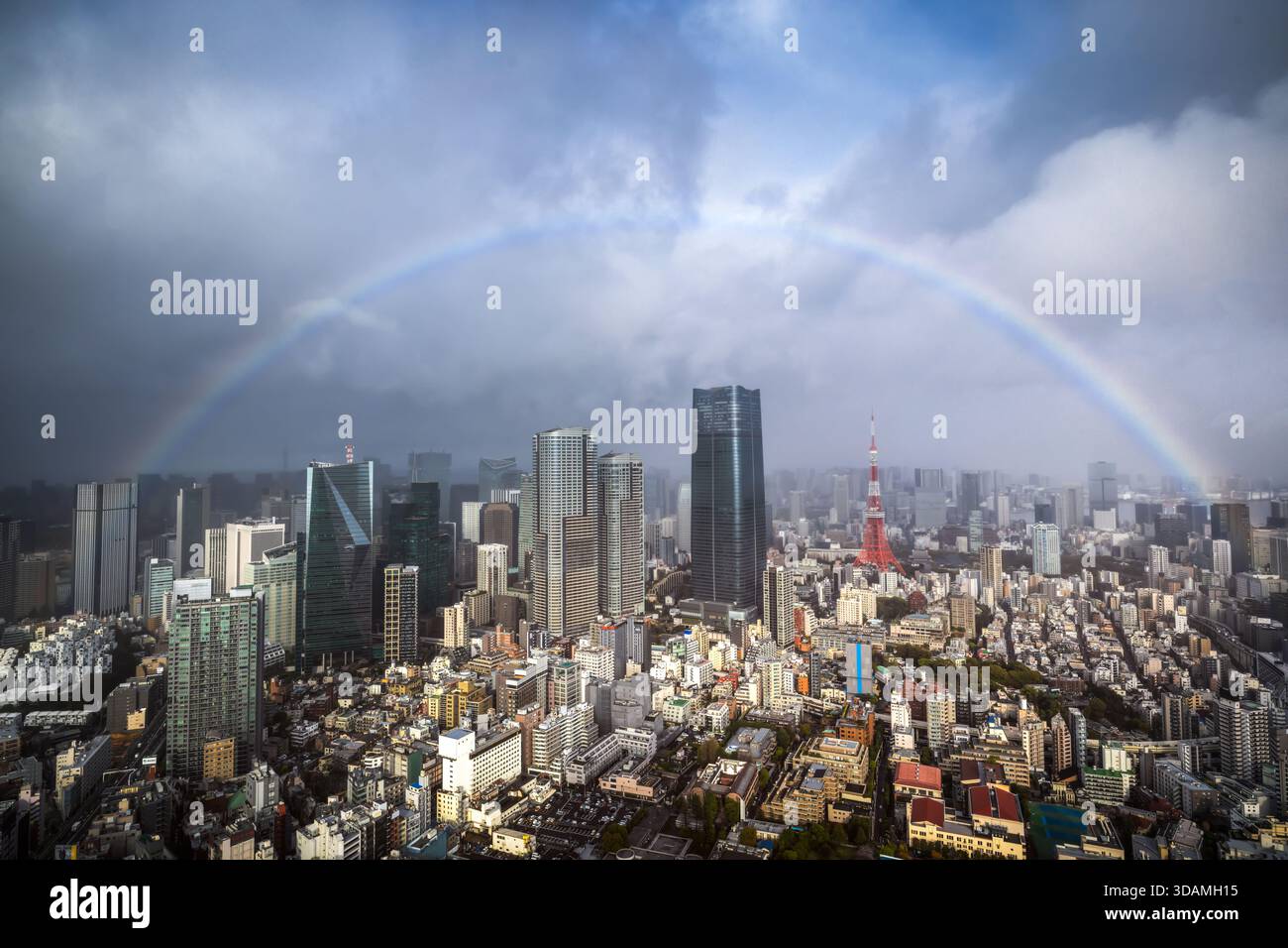 Aerial view of a vibrant rainbow arches over the Tokyo skyline, casting ...