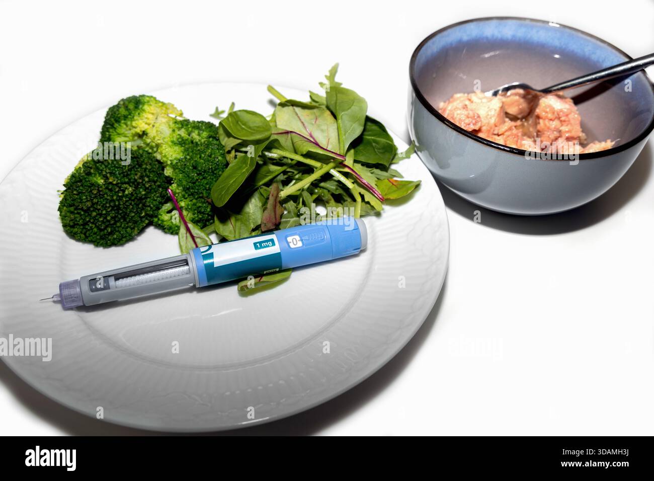 Healthy salad with tuna and Ozempic pen for diet concept Stock Photo ...