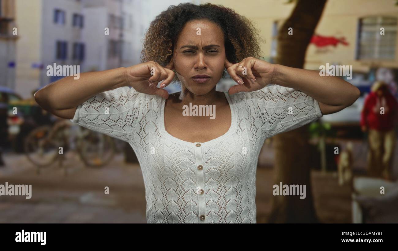 Woman pressing fingers ears on hi-res stock photography and images - Alamy