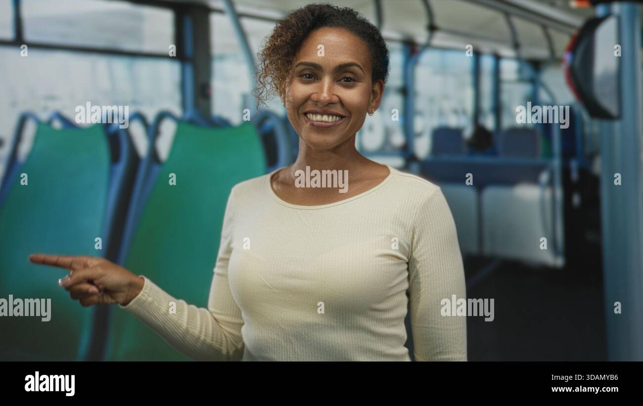 Woman points finger at green bus seat inside bus on street while ...