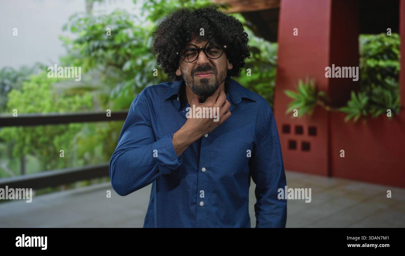 Man curly hair glasses clutching hi-res stock photography and images ...