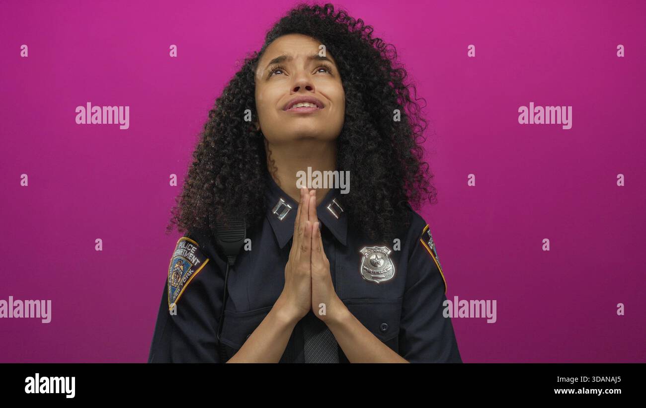 Woman police officer praying against hi-res stock photography and ...
