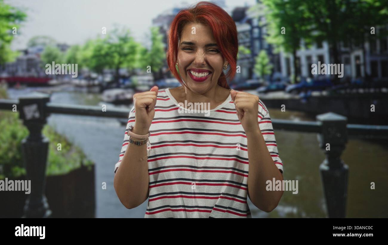 Woman clenches fists smiling broadly hi-res stock photography and ...