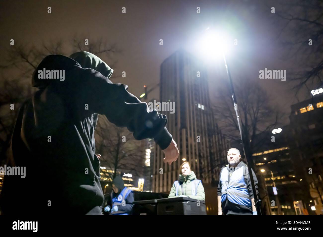 THE HAGUE - Homeless people receive a hot meal from aid workers in the ...