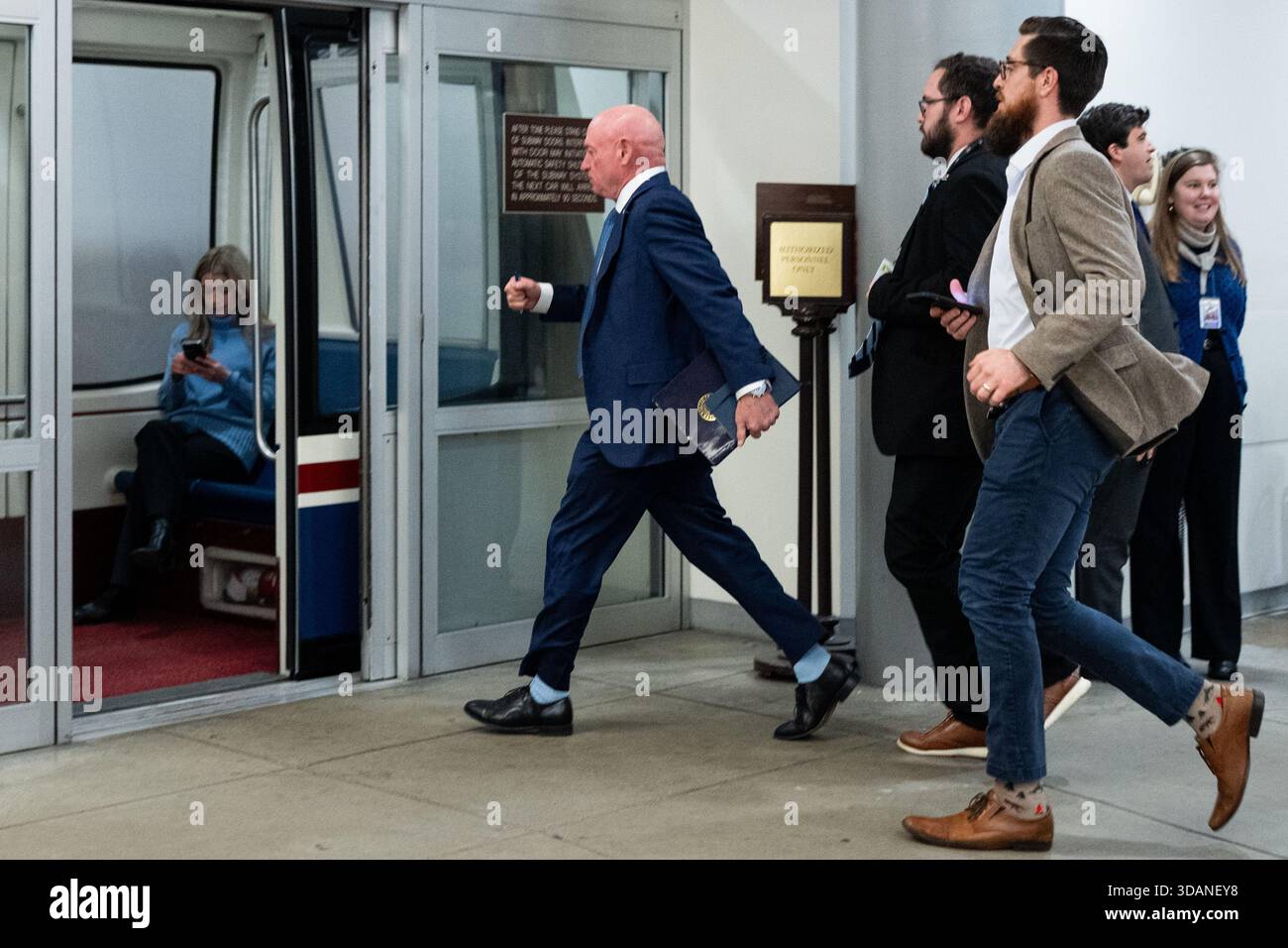 UNITED STATES - DECEMBER 11: Sen. Mark Kelly, D-Ariz., and staffers run ...
