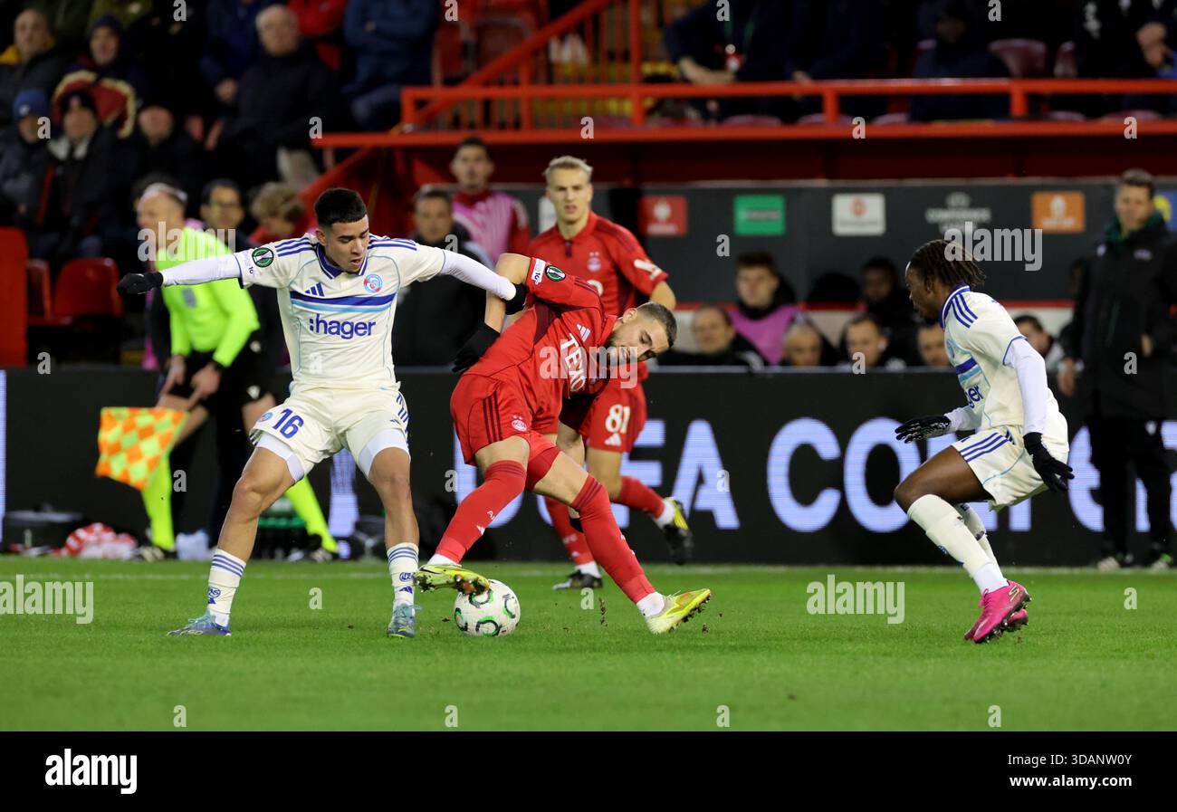 Aberdeen's Adil Aouchiche (centre) and Strasbourg's Kendry Paez (left ...