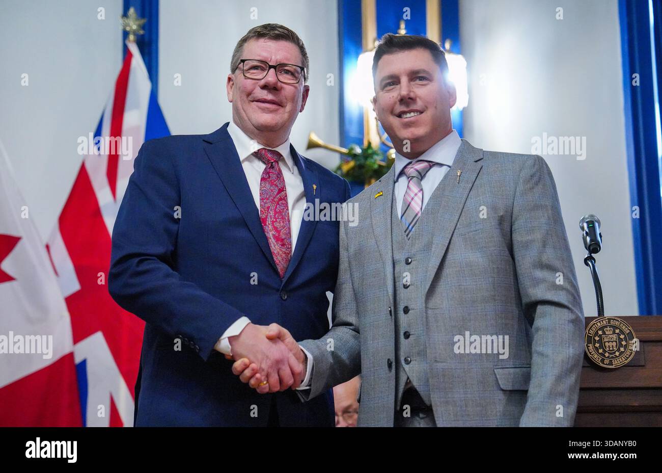 Saskatchewan Premier Scott Moe, left, shakes hands with Michael Weger ...