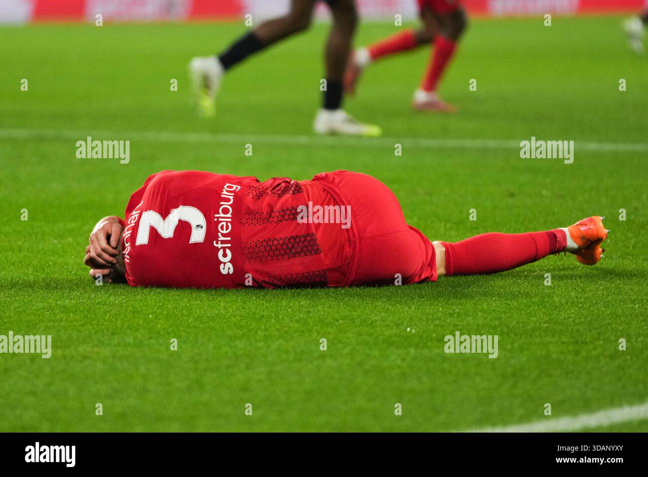 Philipp Lienhart (Freiburg, 3) lying on the ground after a header duel ...