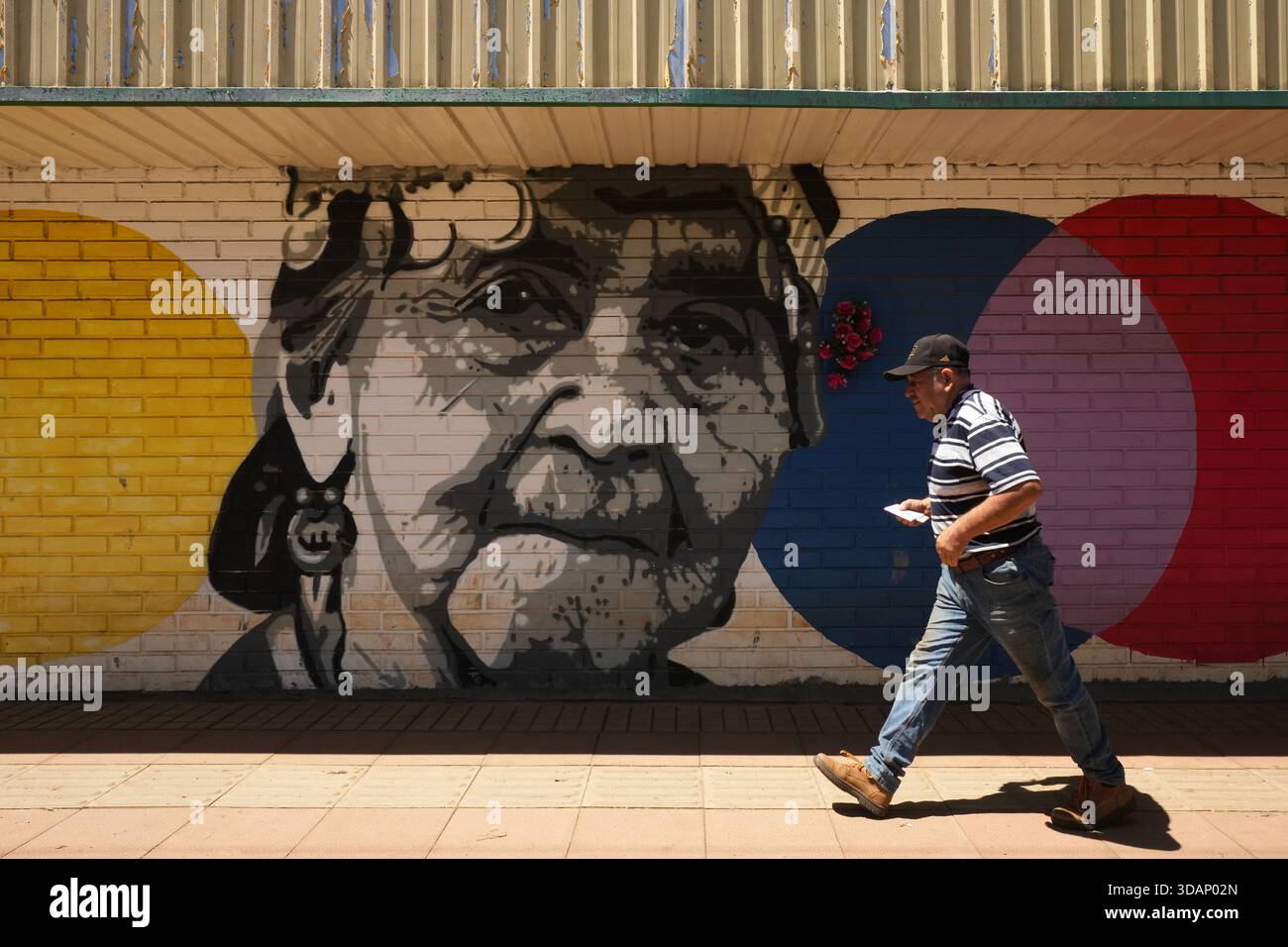 A man walks near a mural of a Mapuche Indigenous woman in Ercilla ...