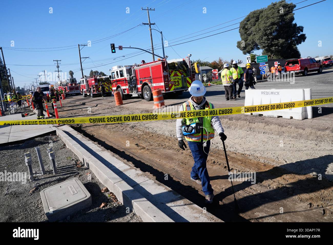 Emergency vehicles are lined up at the scene of a gas explosion ...