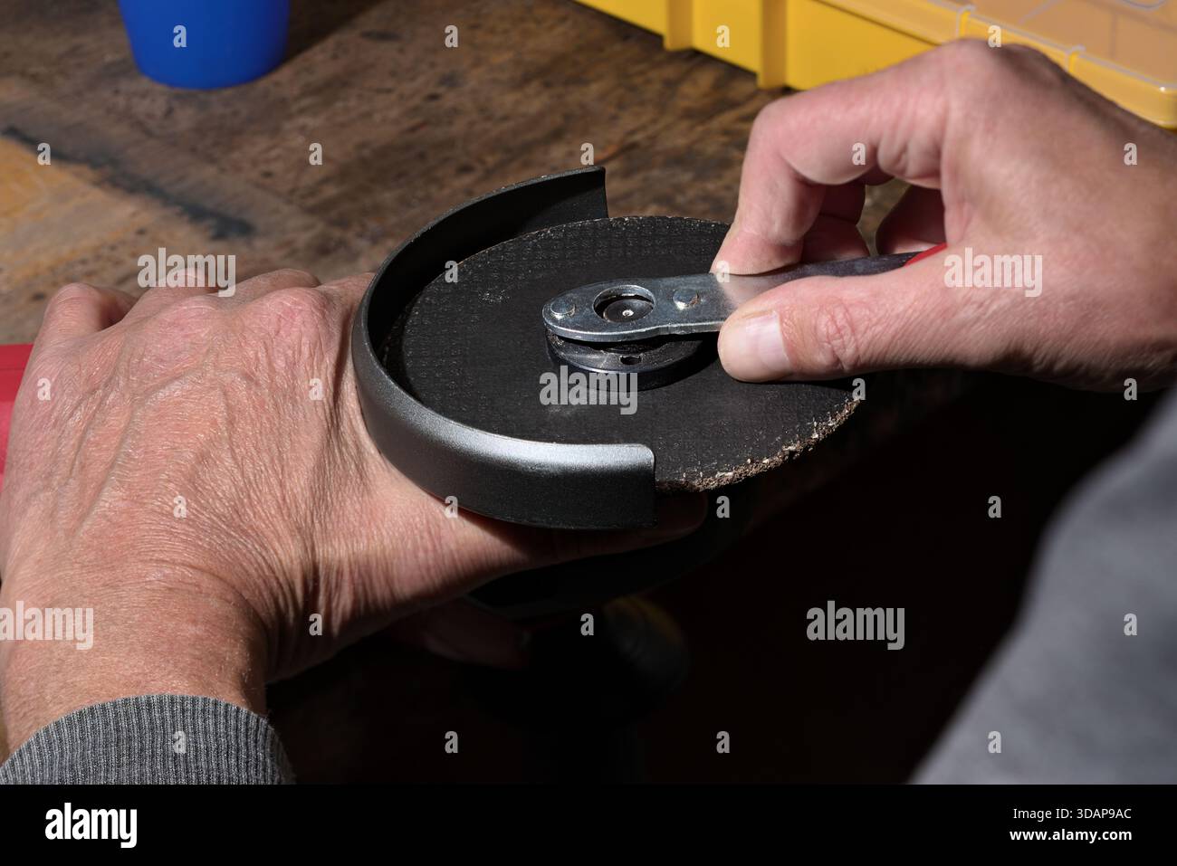 Hand assemble cutting disc wheel on angle grinder machine grinding ...
