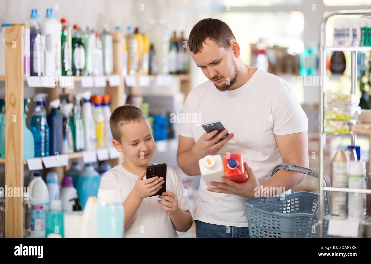 Dad and son scan barcode on packaging of sewer cleaner liquid Stock ...