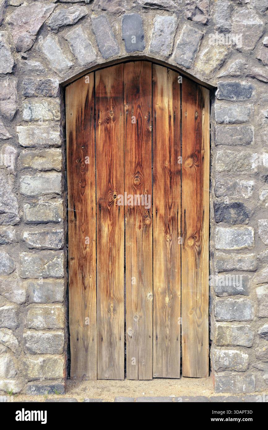 Old time wooden door in medieval stone wall Stock Photo - Alamy