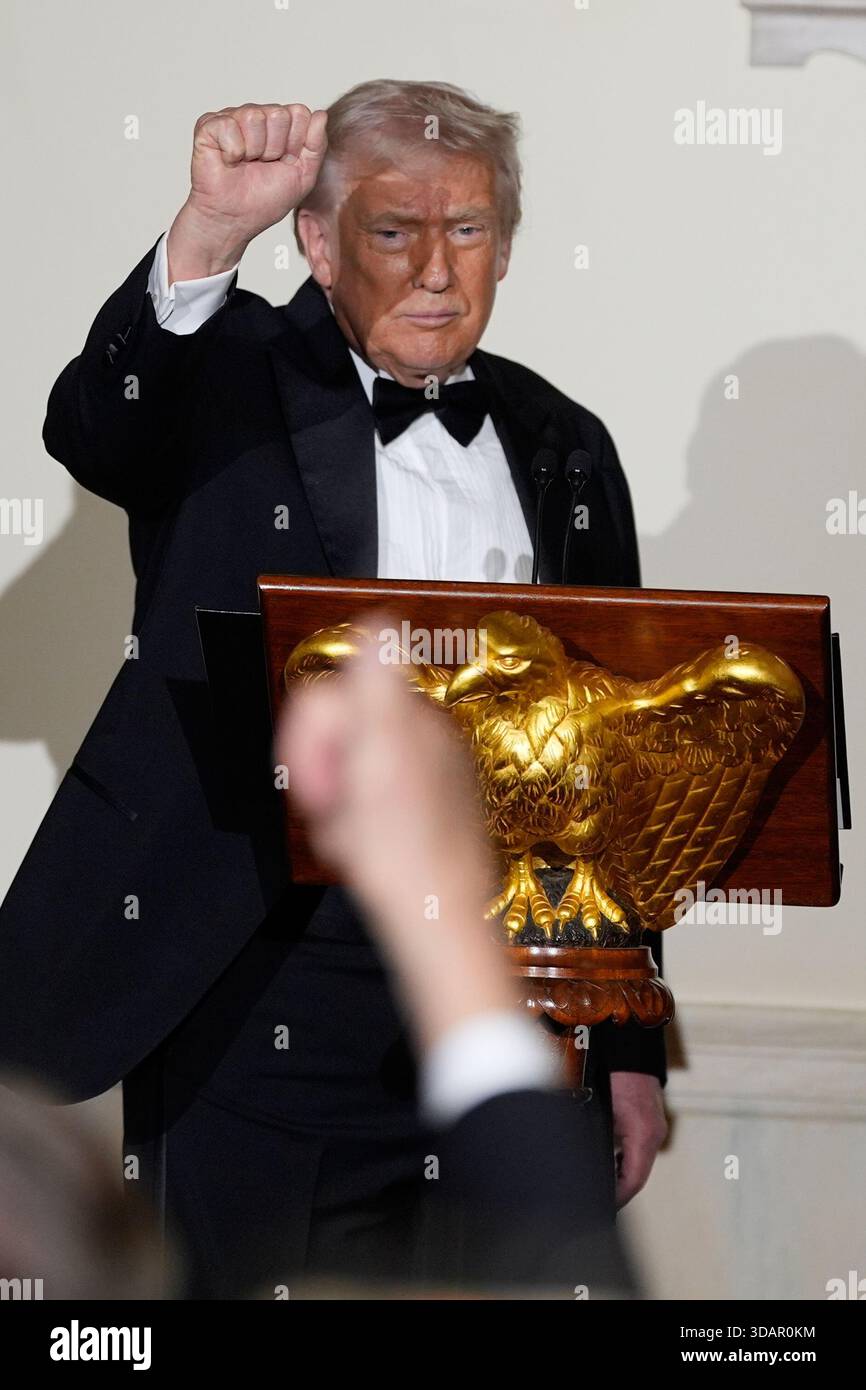 President Donald Trump reacts to guests in the Grand Foyer of the White ...