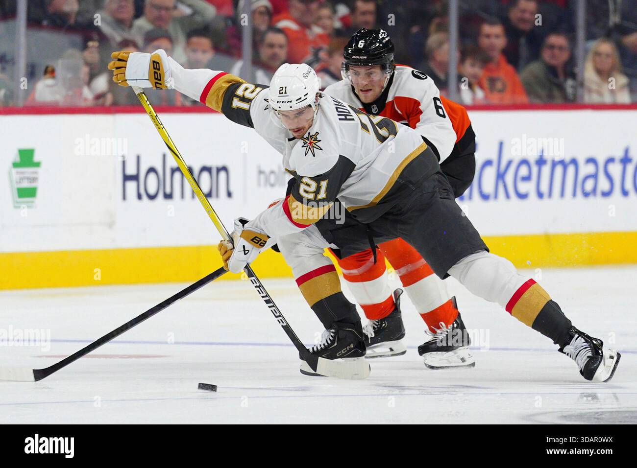 Vegas Golden Knights' Brett Howden, front, plays the puck past ...