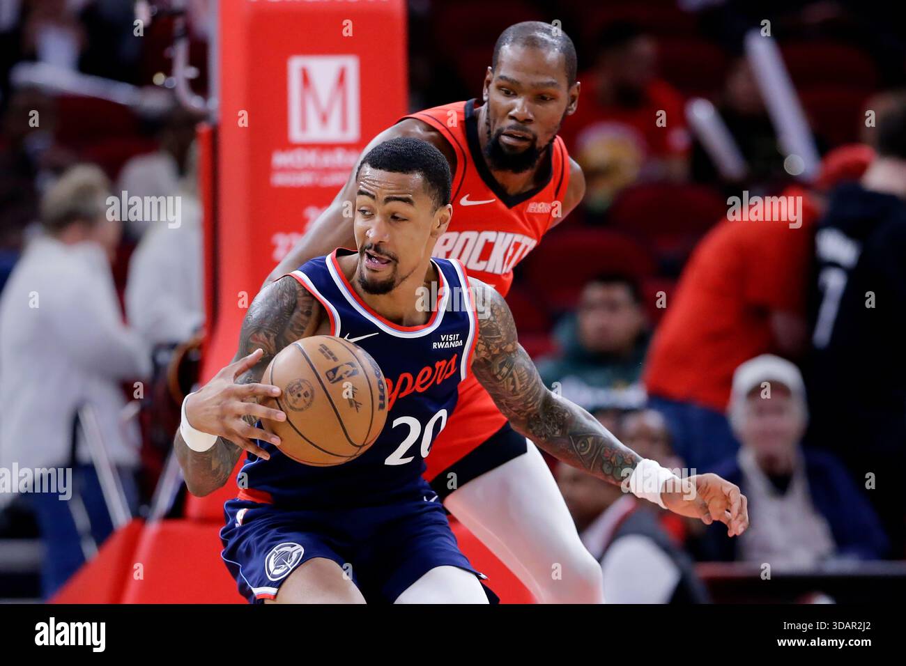 LA Clippers forward John Collins (20) spins to the basket in front of ...