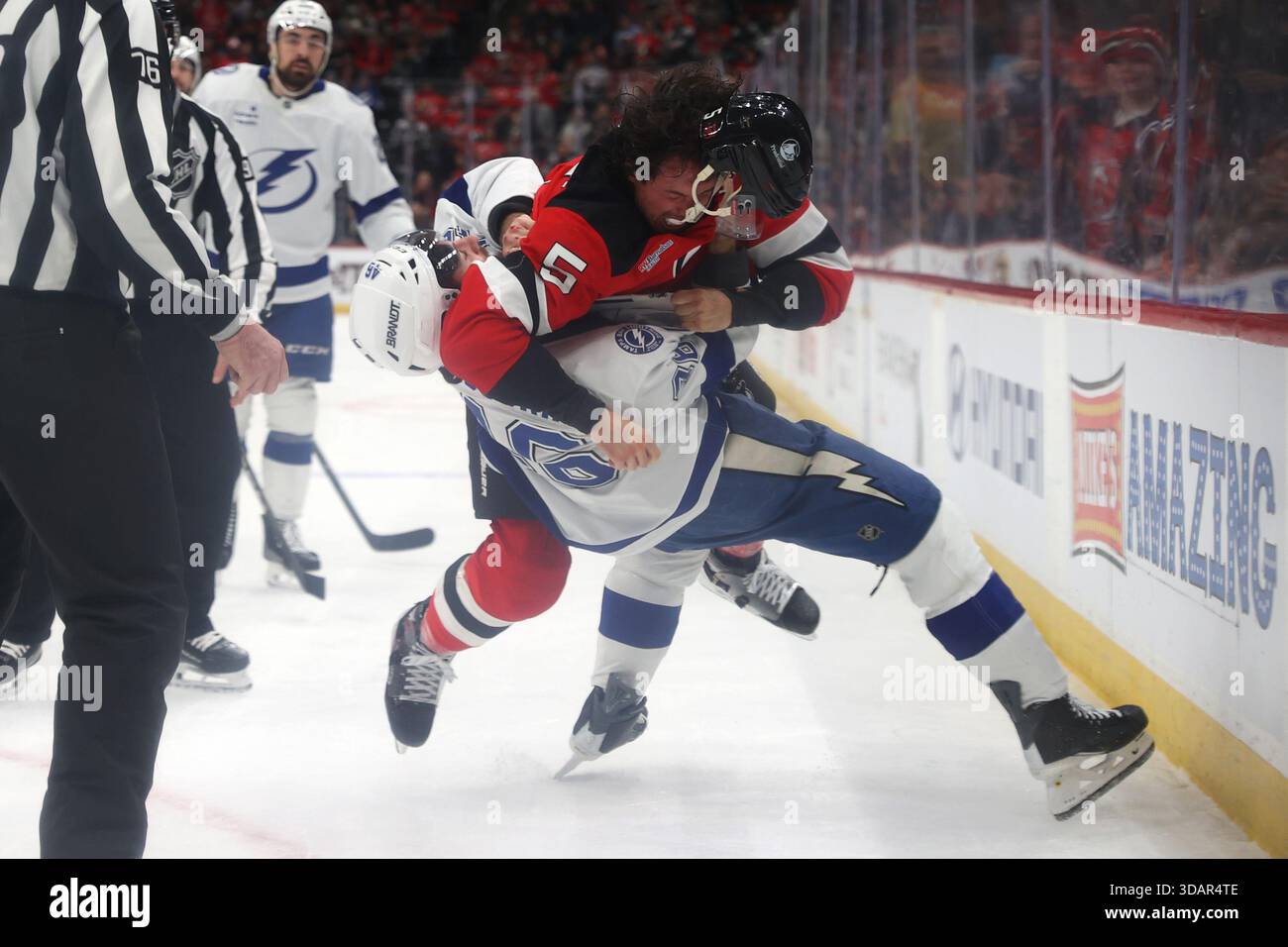 New Jersey Devils' Brenden Dillon (5) fights with Tampa Bay Lightning's ...