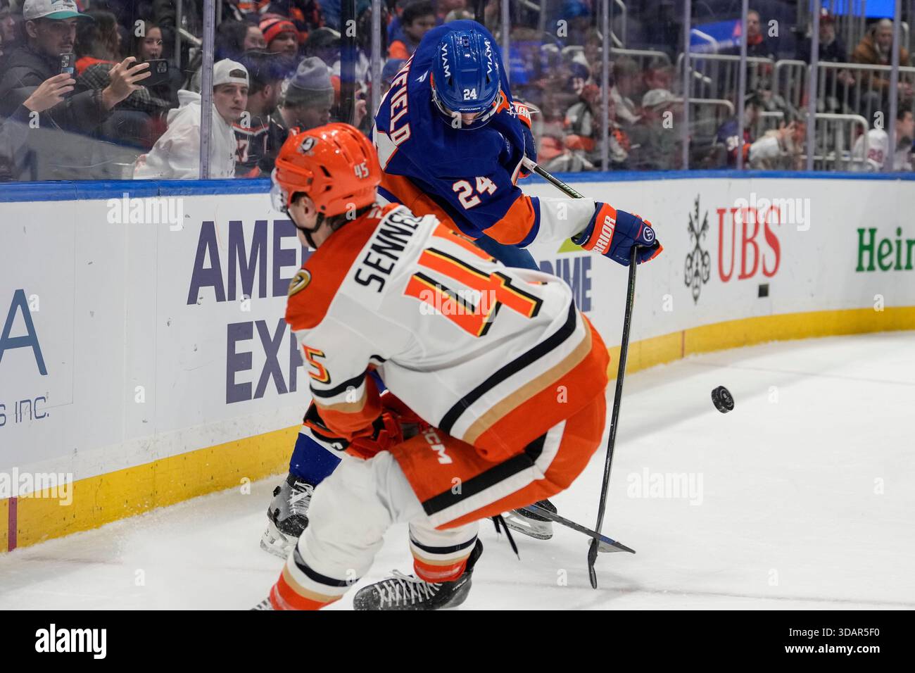 New York Islanders defenseman Scott Mayfield (24) fights for control of ...