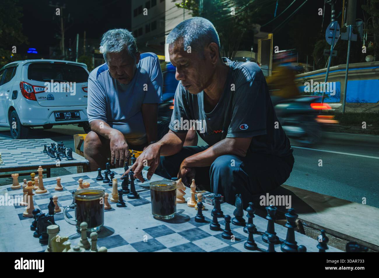 Balikpapan, Indonesia - November 1, 2025. Two local men play an intense ...