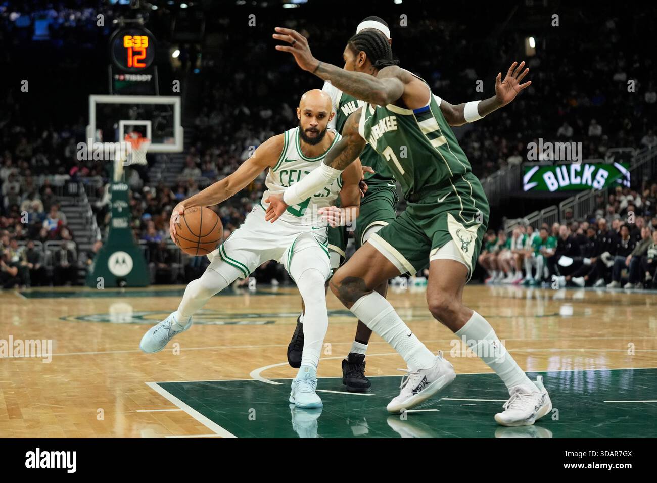 Boston Celtics' Derrick White, left, drives to the basket against ...